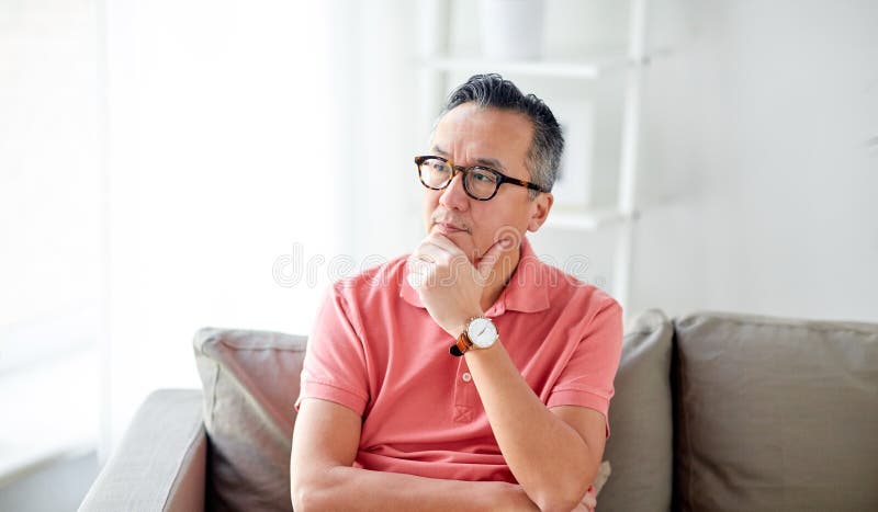 Asian man thinking at home stock photo. Image of pensive - 89825832