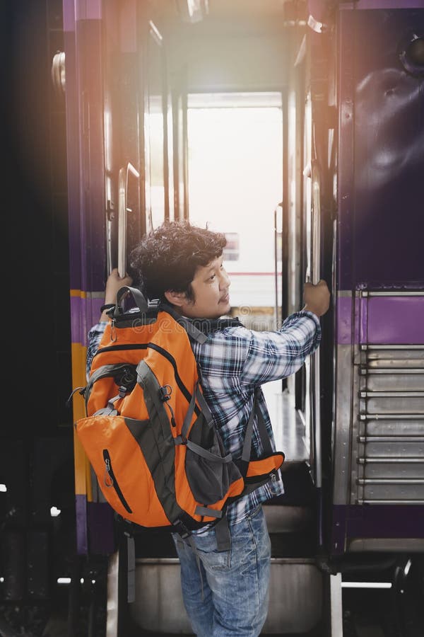 Asian Man Traveler with Backpack is Stepping Up the Train in Train ...