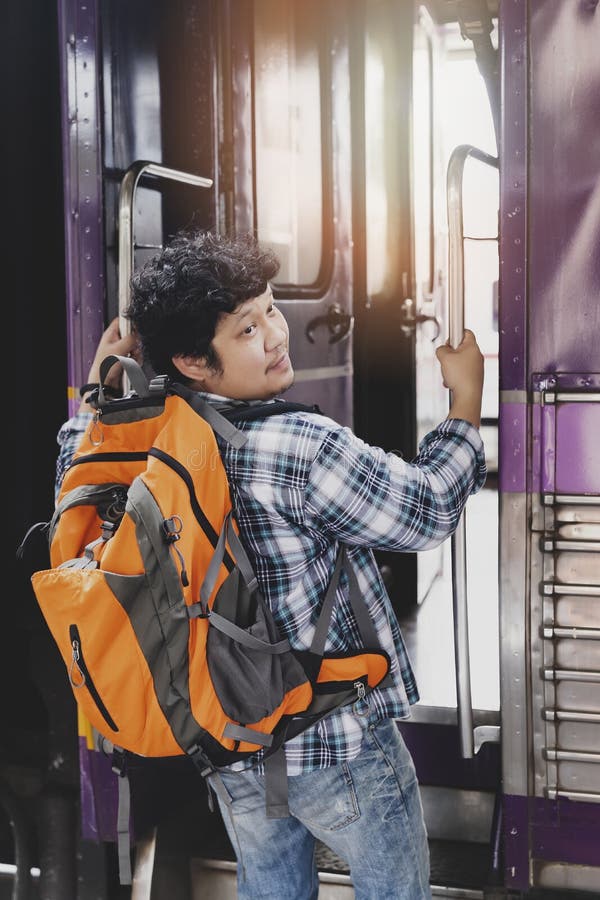 Asian Man Traveler with Backpack is Stepping Up the Train in Train ...