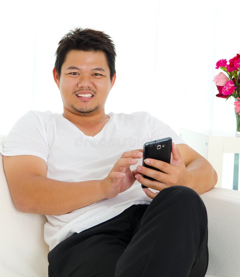 Asian man using handphone stock image. Image of handsome - 68661379