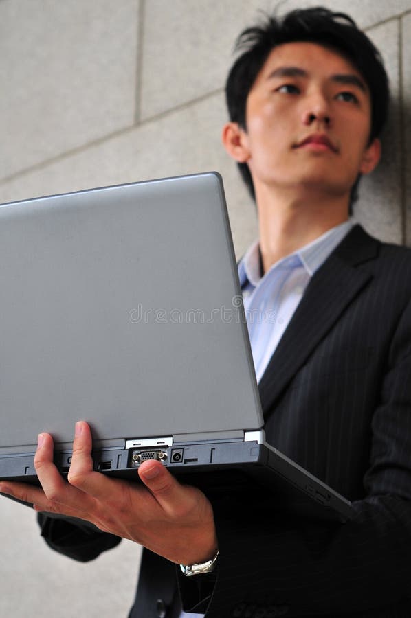 Asian Man using a laptop stock image. Image of suit, korean - 9427517