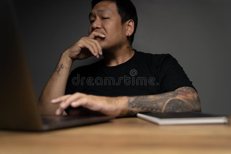 Asian Man Using Laptop with Boring Face on Wooden Table with Laptop ...