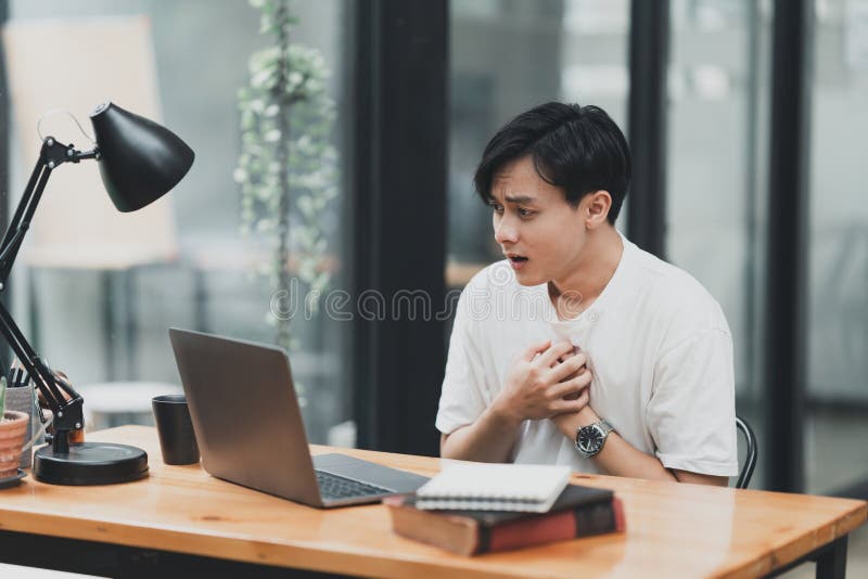 Asian Man Using Laptop Computer Shocking while Have a Bad News Stock ...