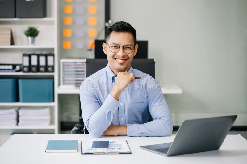 Asian Man Using Laptop and Tablet while Sitting at Her Working Place ...