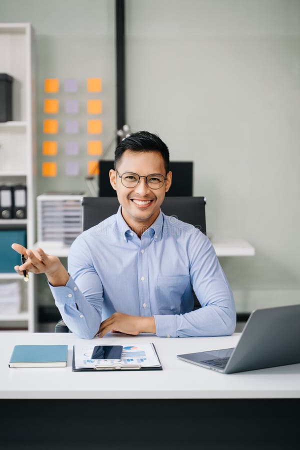 Asian Man Using Laptop and Tablet while Sitting at Her Working Place ...