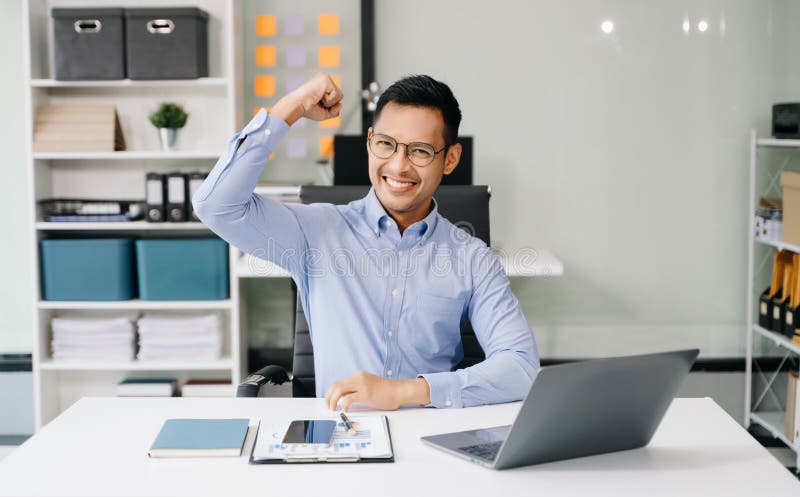 Asian Man Using Laptop and Tablet while Sitting at Her Working Place ...