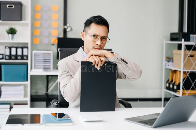 Asian Man Using Laptop and Tablet while Sitting at Her Working Place ...