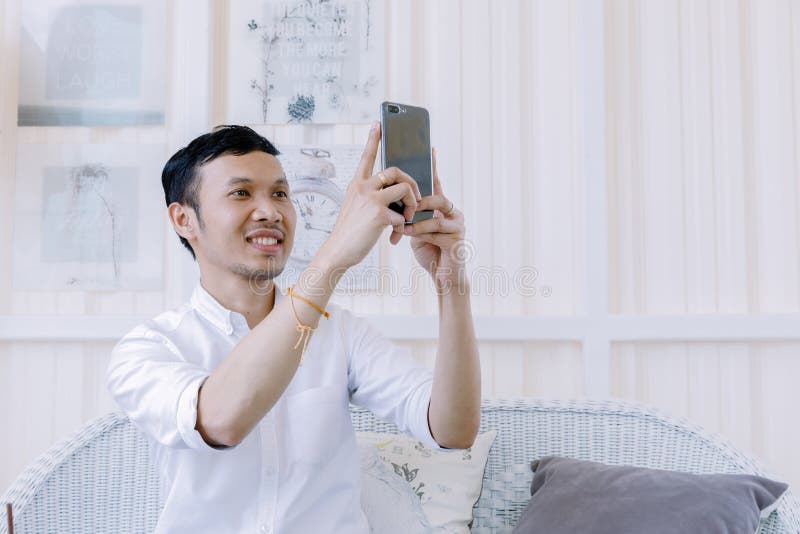 Asian Man Using a Mobile Phone in Bakery Shop Stock Photo - Image of ...