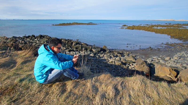 Asian Man Using Smart Phone for Internet in Remote Nature Area O Stock ...