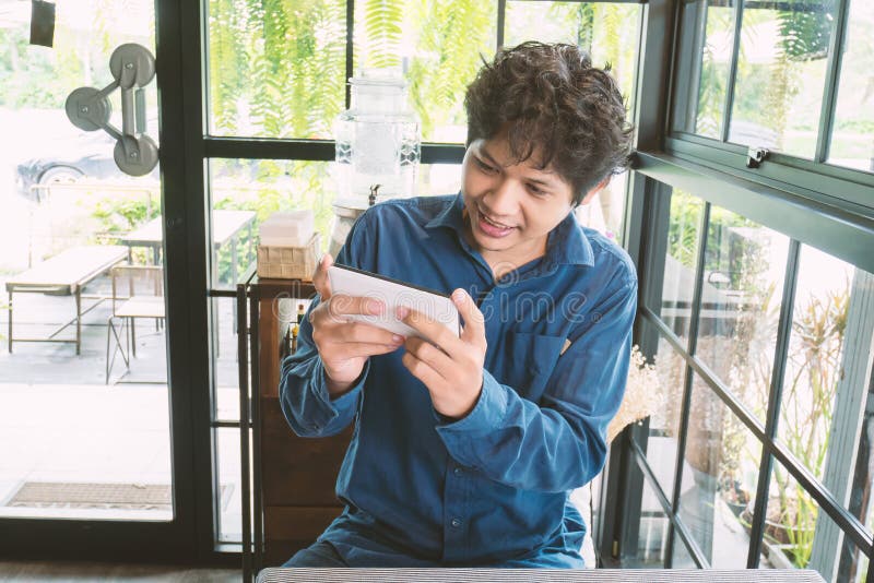 Asian man using smartphone stock photo. Image of phone - 99724468