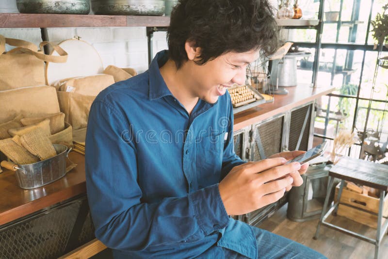 Asian man using smartphone stock image. Image of lifestyle - 99724593