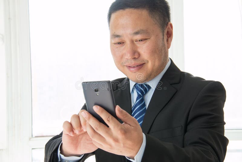 Asian man using smartphone stock image. Image of person - 49679029