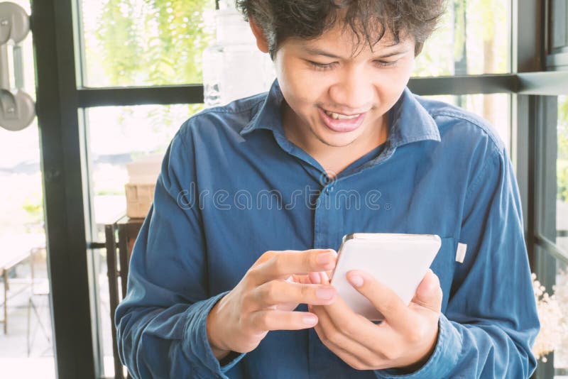 Asian man using smartphone stock image. Image of coffee - 101904475