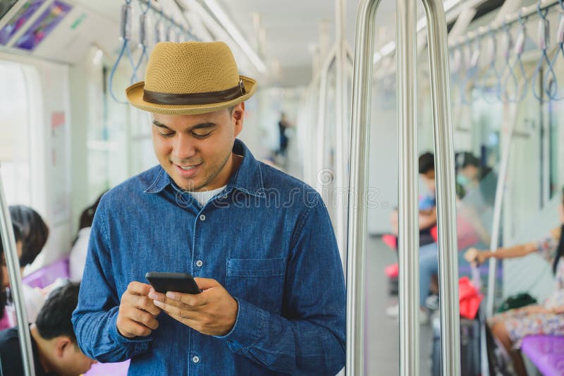 Asian Man Using Smartphone in Sky Train Stock Photo - Image of device ...