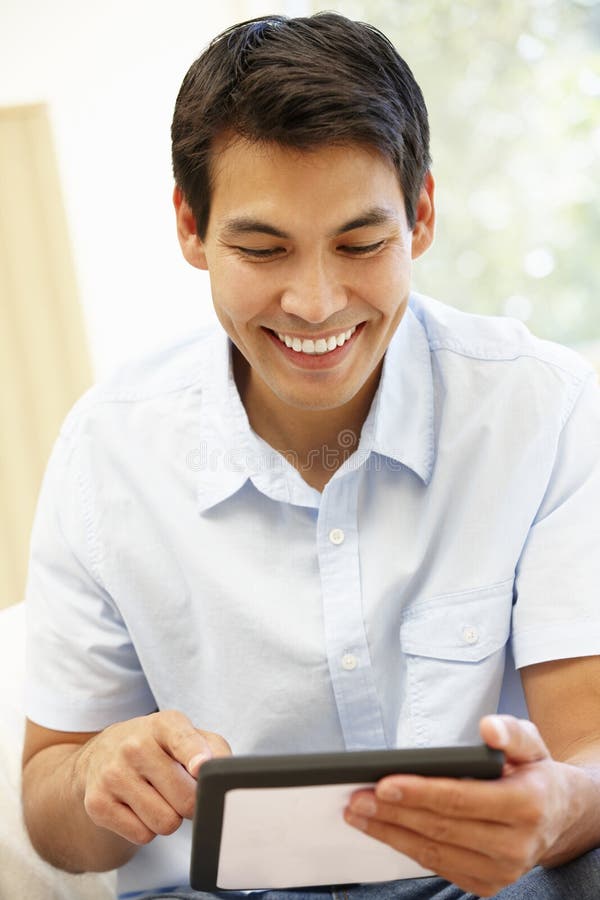 Asian man using tablet stock image. Image of leisure - 55893377