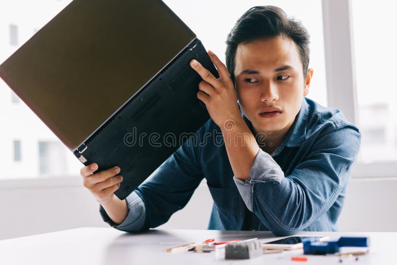 The Asian Man Was Taking Out a Broken Computer To Repair it Stock Photo ...