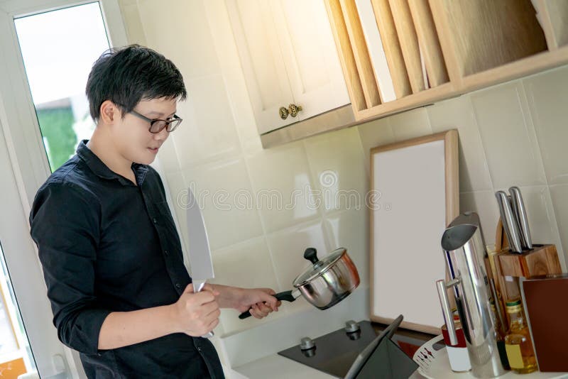 Asian Man Watching Tutorial Cooking in the Kitchen Stock Photo - Image ...