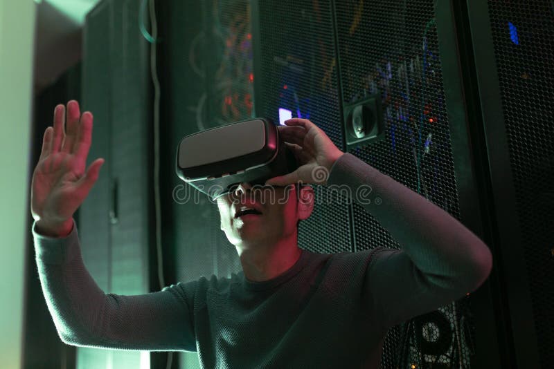 Asian Man Wearing Vr Headset while Sitting in Computer Server Room ...