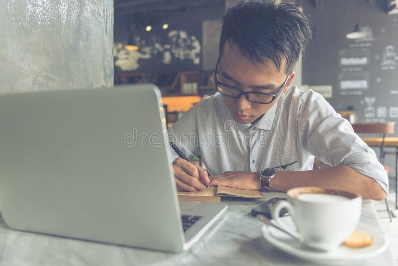 Asian Man in White Shirt Writing into Notes Stock Image - Image of ...