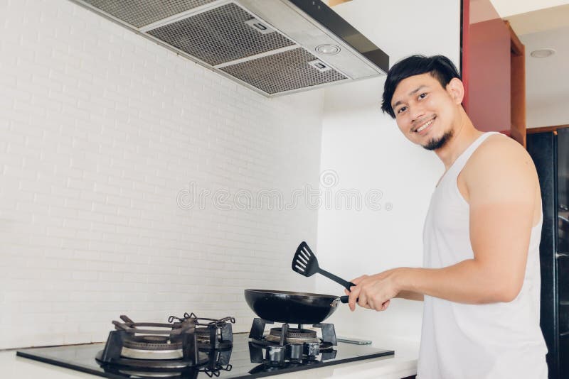 Man in White Tank-top is Cooking Breakfast in the Kitchen. Stock Image ...
