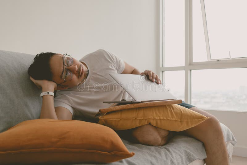 Man Woking Boring Job with Computer in His Room Sitting on the Sofa ...
