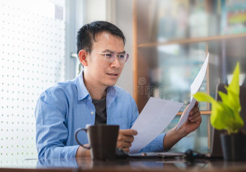 Asian Man Working with Documents and Laptop in Home Stock Photo - Image ...