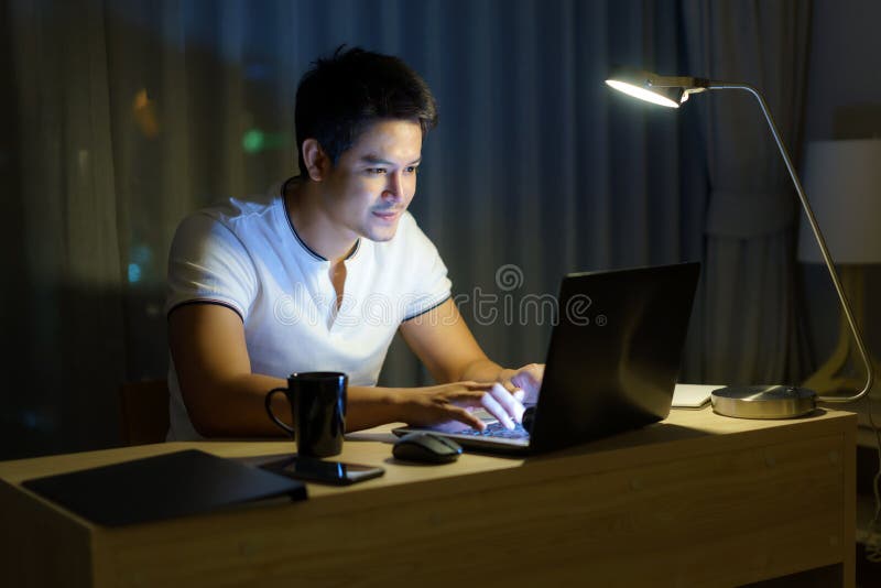 Asian Man Working at Home are Sitting in Front of a Computer Late at ...