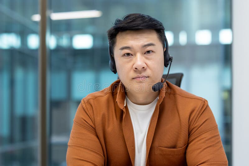 Asian Man Wearing Headset at Work in a Modern Office Environment Stock ...