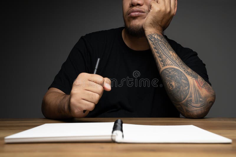 Asian Man Writing on a Note Book with Thinking Face on Wooden Table ...