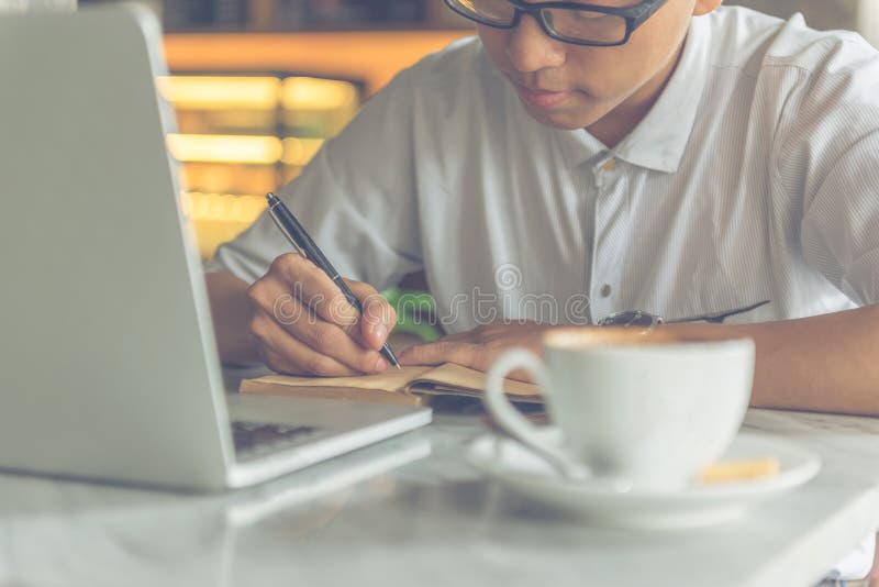 Asian Man Writing Notes at the Cafe Stock Photo - Image of notebook ...