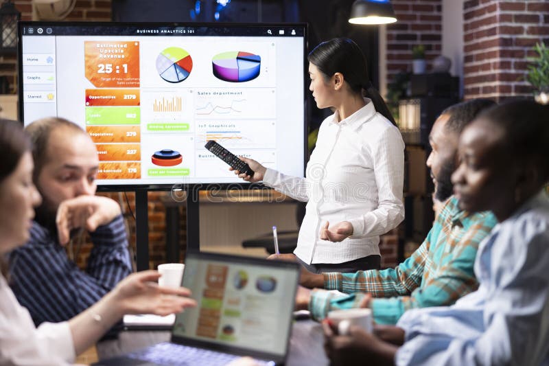 Asian Manager Discussing Business Analytics with Team Stock Image ...