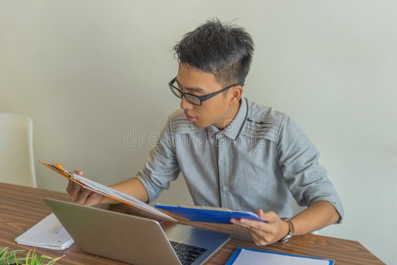 Asian Manager Reading Reports in the Office Stock Image - Image of note ...