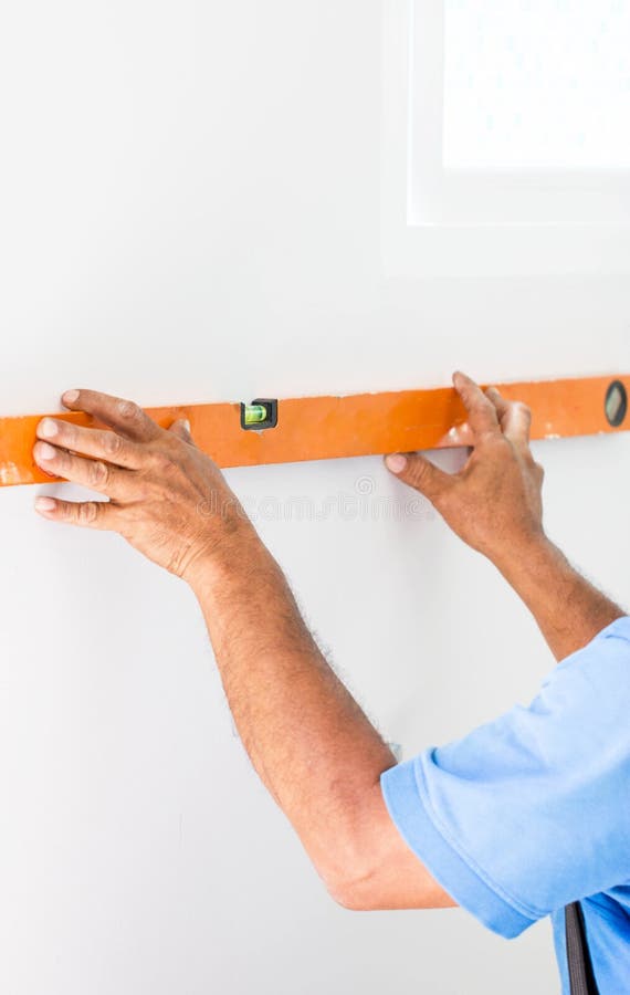 Asian Mans Hand Measuring a Wall with Spirit Level Stock Image - Image ...