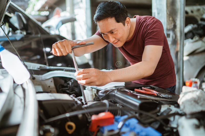 Asian Mechanic Man Using T Socket Repairing a Car Engine Stock Photo ...
