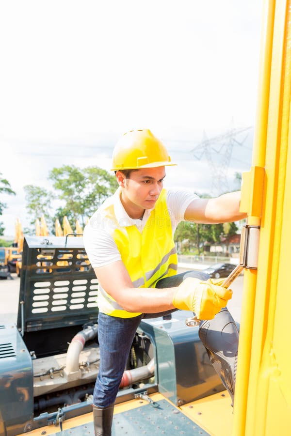 Asian Mechanic Repairing Construction Vehicle Stock Photo - Image of ...