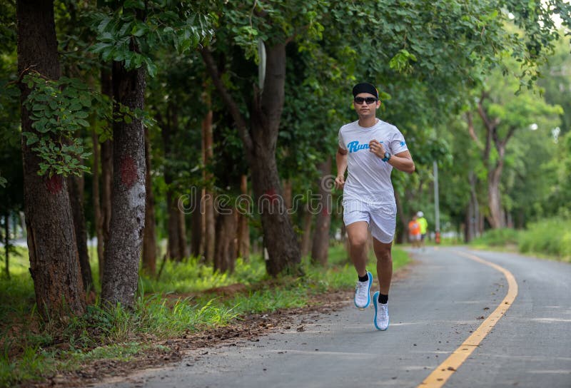 Asian Men Jogging and Running in the Park Stock Photo - Image of person ...