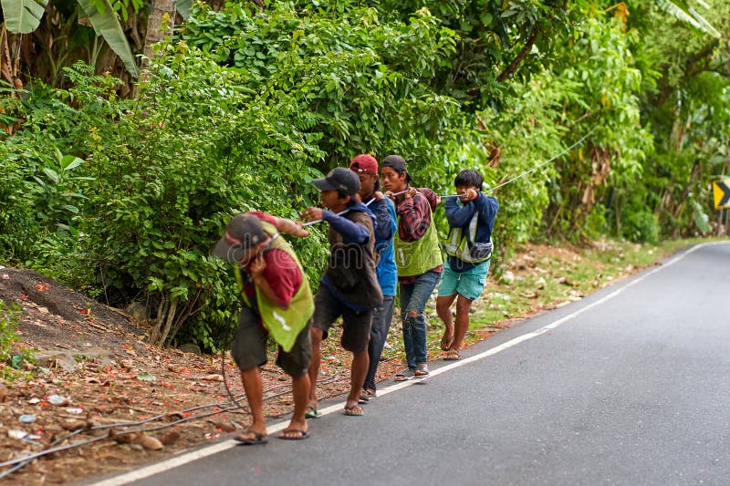 Asian Men Pulling Wire Along the Road Editorial Stock Photo - Image of ...