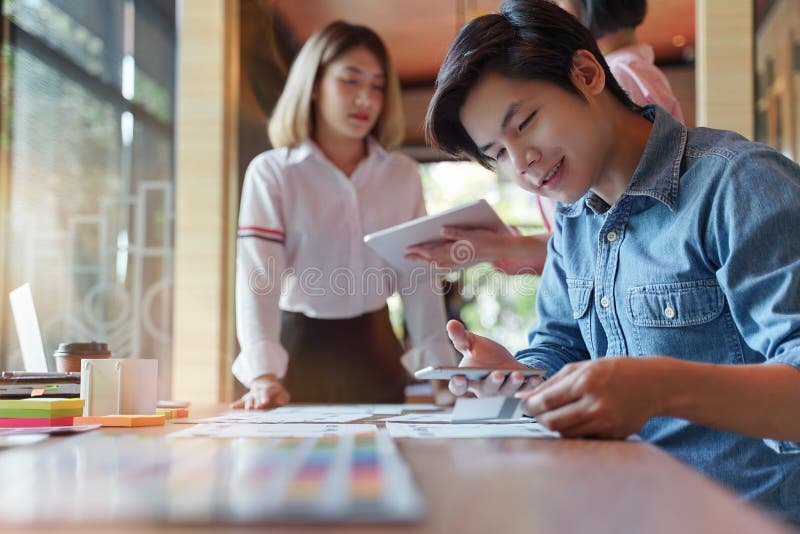 Asian Mobile Apps Developers Team Designing, Discussing Together on a ...