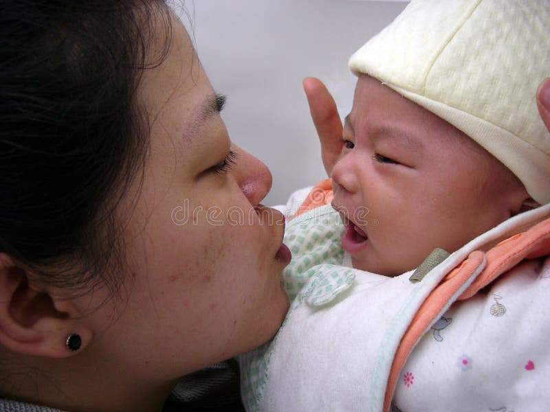 Asian Mother and Daugher Murmuring Stock Image - Image of kiss, women ...