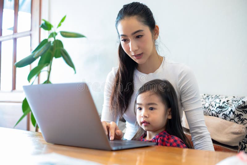 Asian Mothers Are Teaching Their Daughters To Read A Book And Use