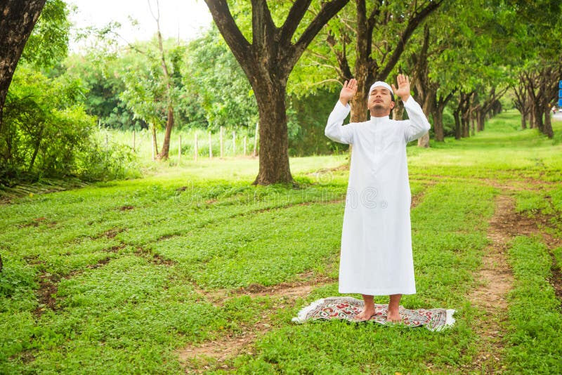 Asian Muslim Man Standing and Praying while Raised Arms on the Dune ...