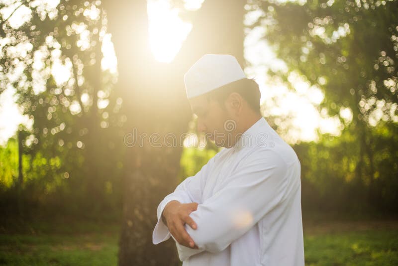 Asian Muslim Man Standing and Praying while Raised Arms on the Dune ...