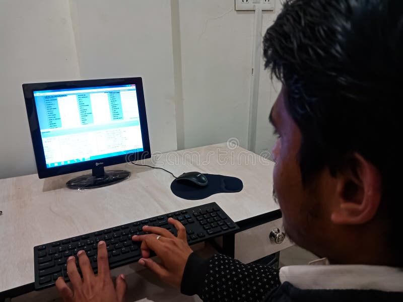 An Asian Office Staff Male Executive Working at Desktop Computer in ...