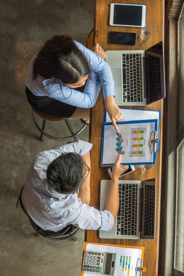 Asian Office Worker Talking about Data on Financial Document Stock ...