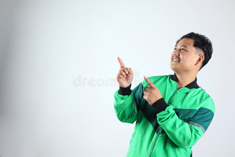 Asian Online Driver with Unifrom Jacket Pointing at Copy Space Stock ...