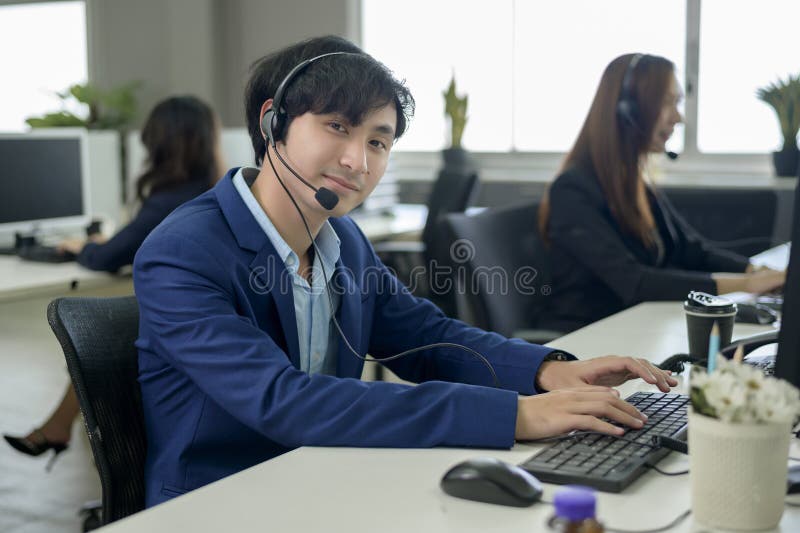 Asian Operators are Wearing Headphone Working in Workplace Stock Image ...