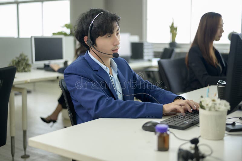 Asian Operators are Wearing Headphone Working in Workplace Stock Image ...