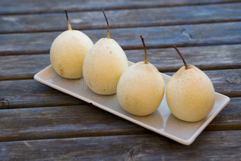 Asian pears on wood table stock photo. Image of single - 13359908