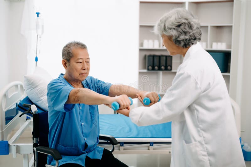 Asian Physiotherapist Helping Elderly Man Patient Stretching Arm during ...