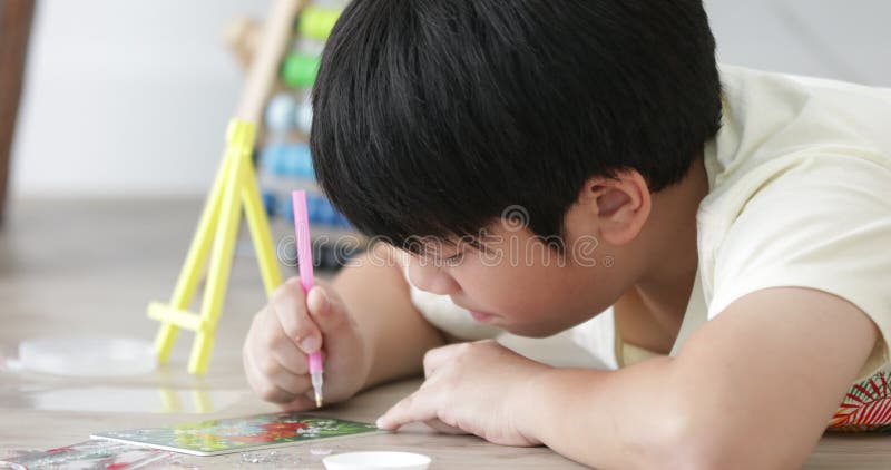 Asian Preteen Boy Doing Handcraft on the Floor. Stock Footage - Video ...